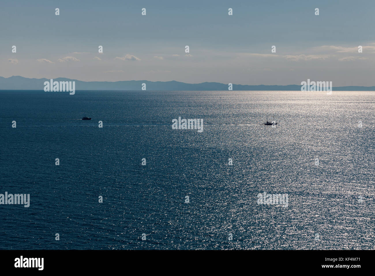 blue sea with two boats, water surface Stock Photo - Alamy