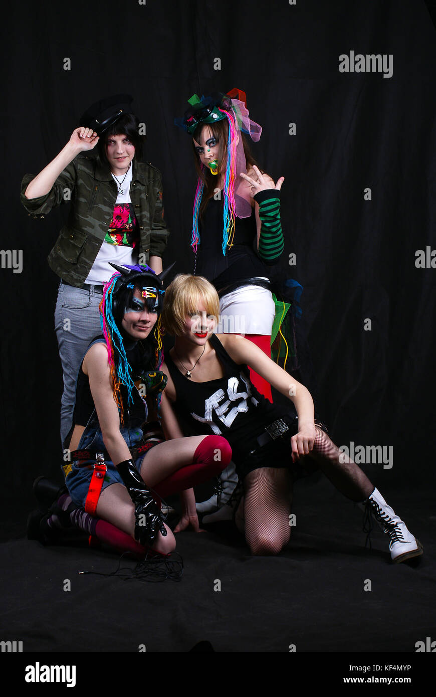 Four girls posing in the style of cosplay.Isolated studio portrait ...