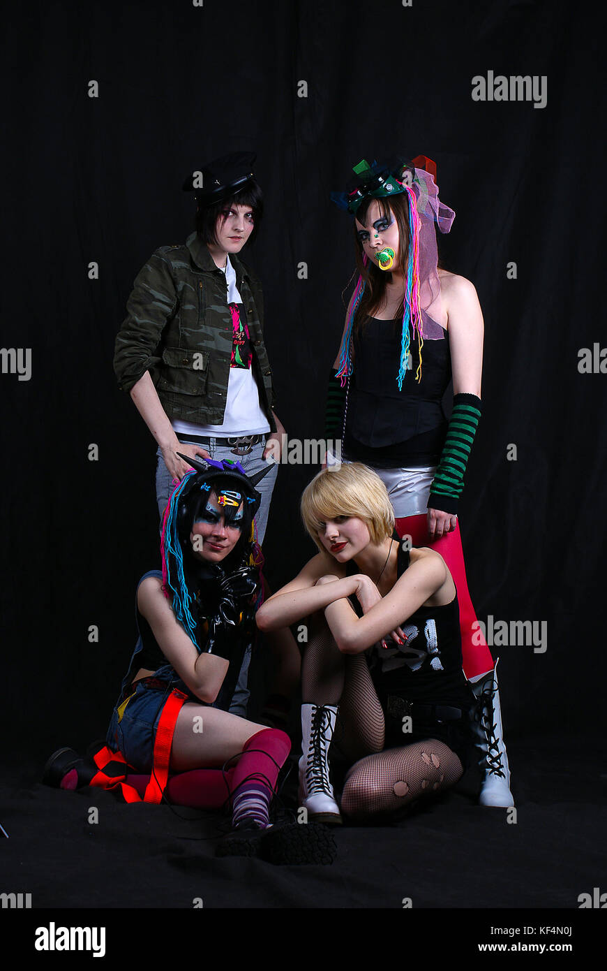 Four girls posing in the style of cosplay.Isolated studio portrait ...