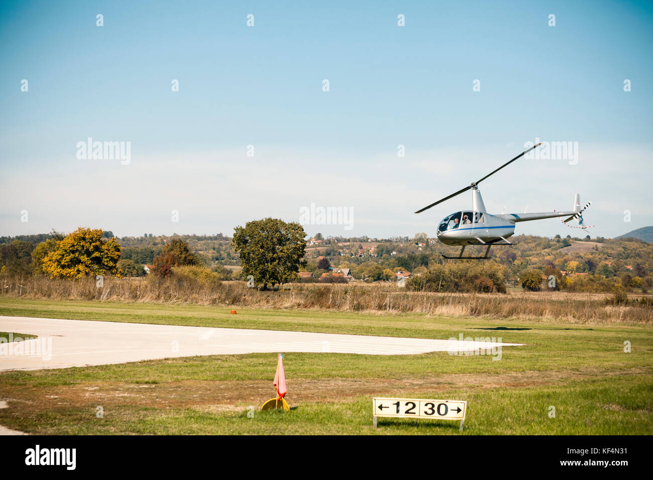 helicopter flying very low from the ground Stock Photo - Alamy