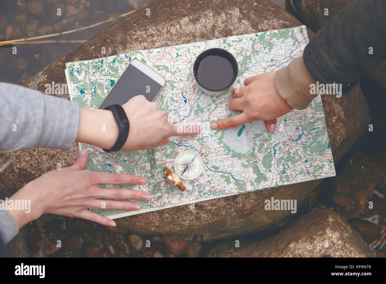Scout tourists plan the route, orientate on the terrain on the map and ...