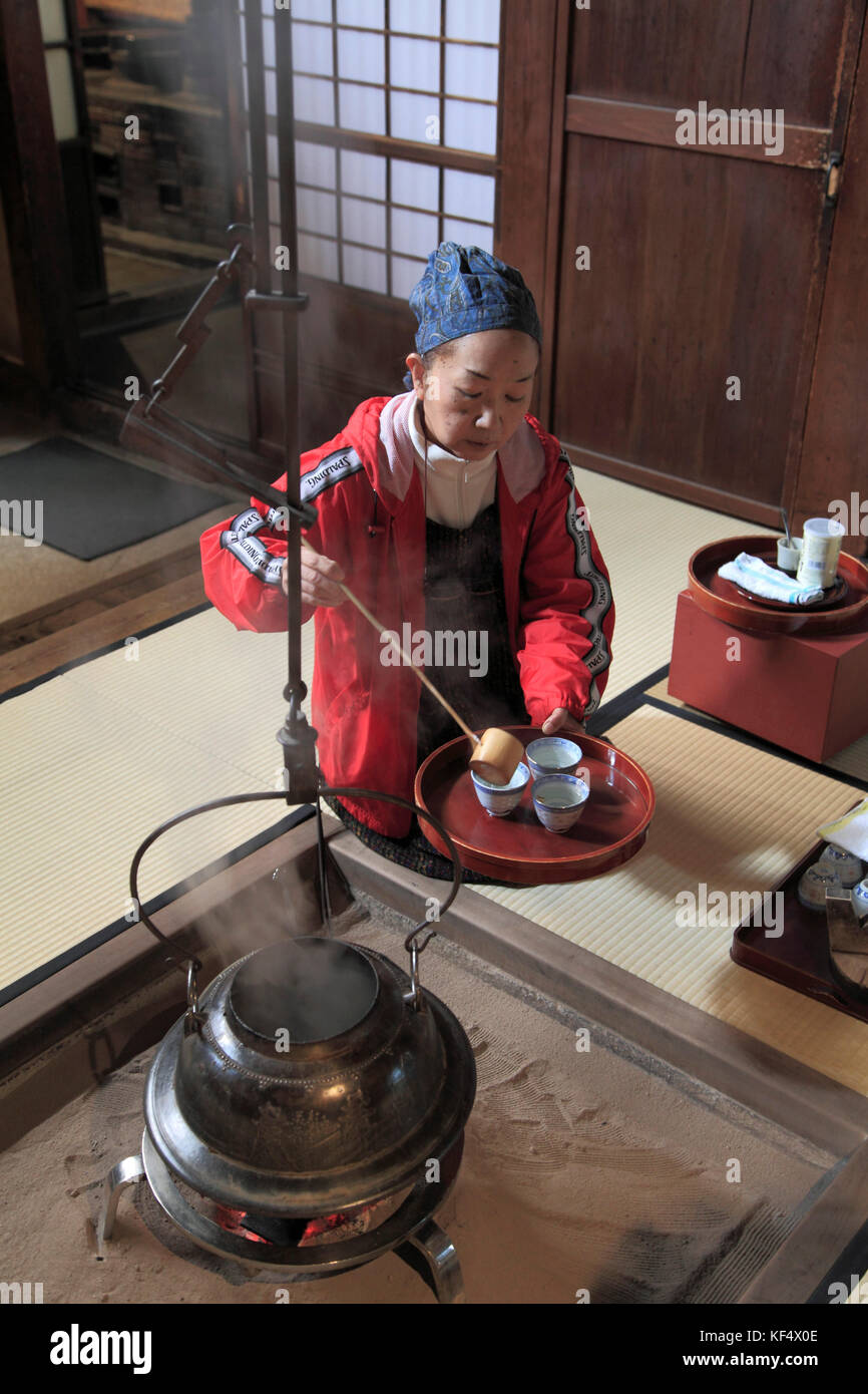 Japan, Hida, Takayama, Kusakabe Heritage House, interior, woman serving ...