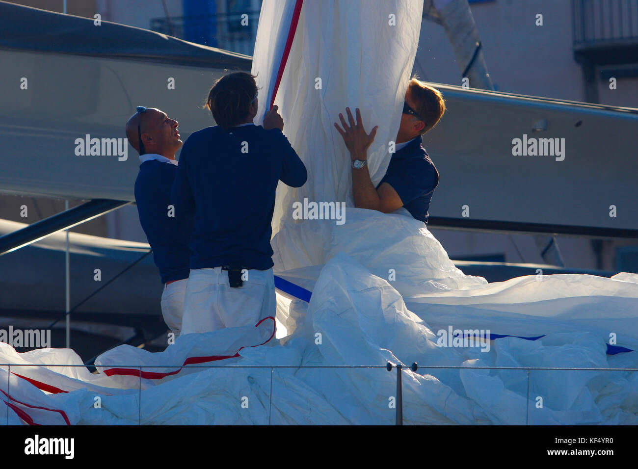 France, on a big yacht three sailors and white sail Stock Photo - Alamy