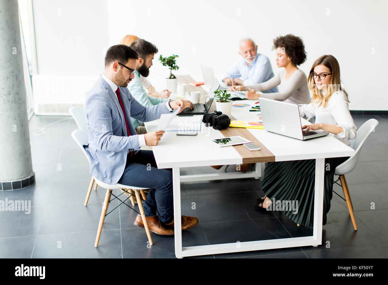 View of multiracial business people around table during staff meeting ...