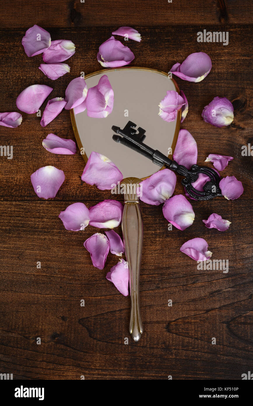 mirror with key and rose petals Stock Photo - Alamy