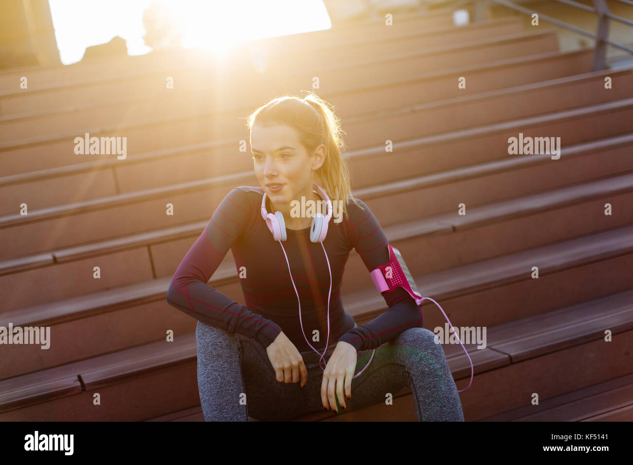 Attractive female runner taking break after jogging outdoors Stock ...