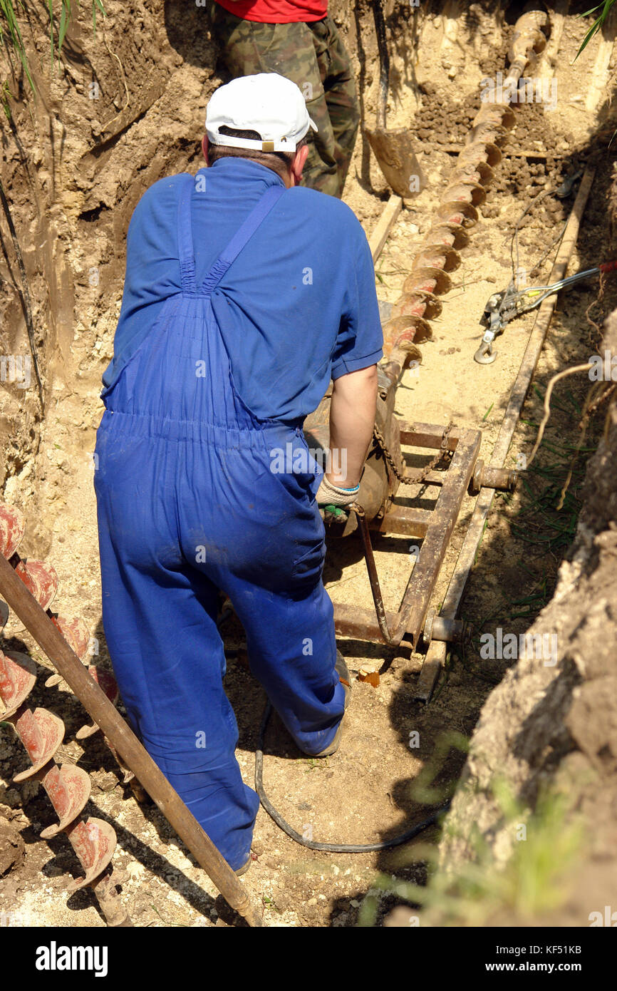 Construction worker working in excavation with horizontal drilling ...