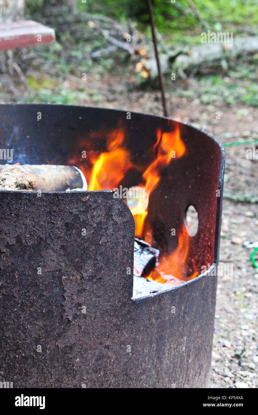 A fire burning in a metal fire ring Stock Photo - Alamy