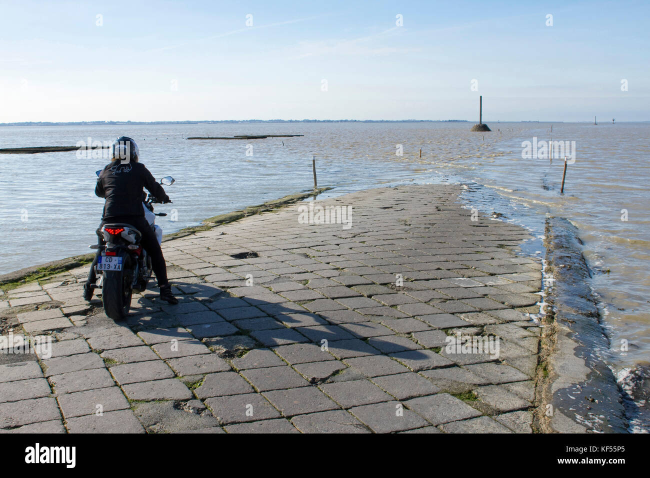 France, Vendee, biker on the "Passage du Gois" at rising tide Stock ...
