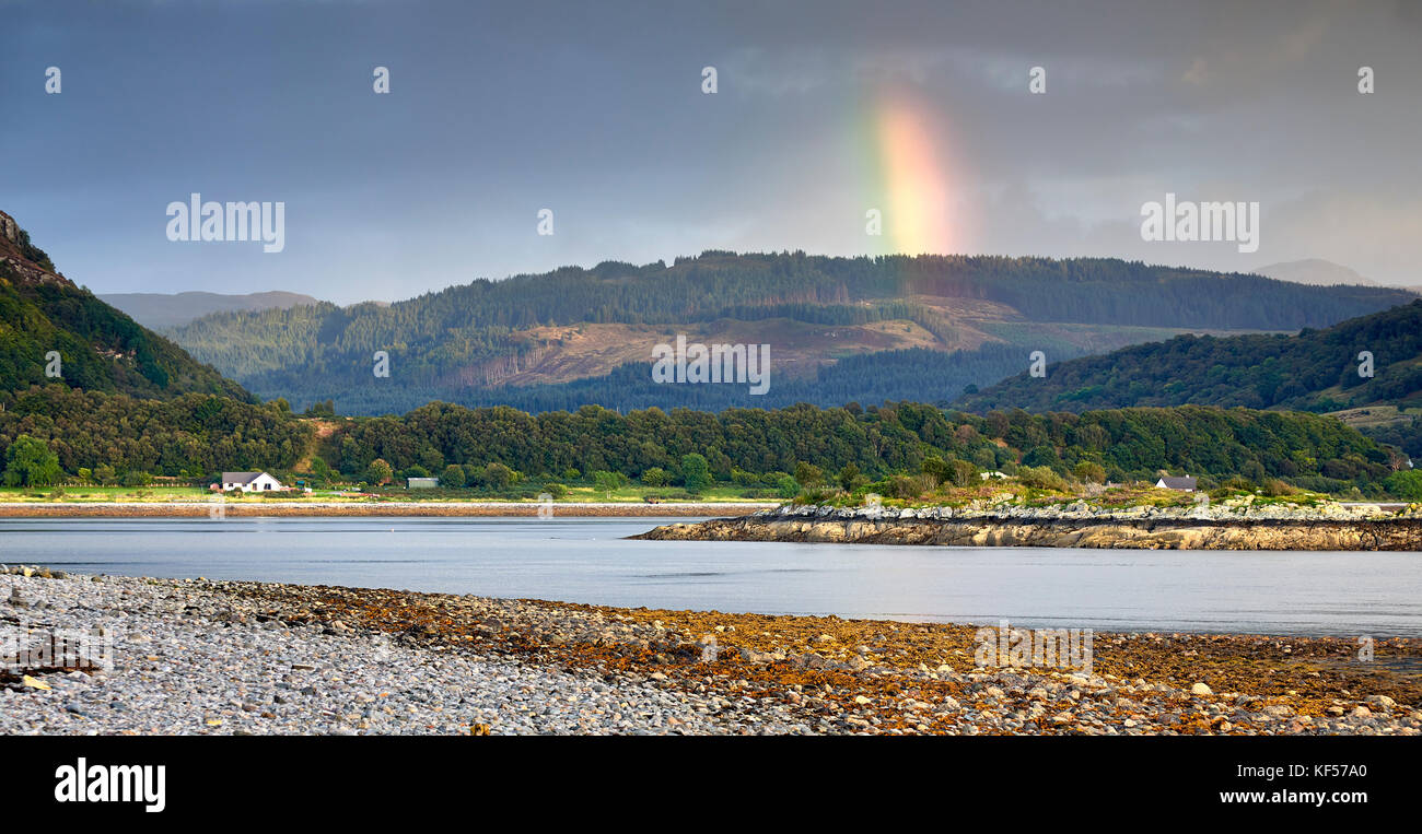 Rainbow and watery sky looking south west across Loch Carron towards ...