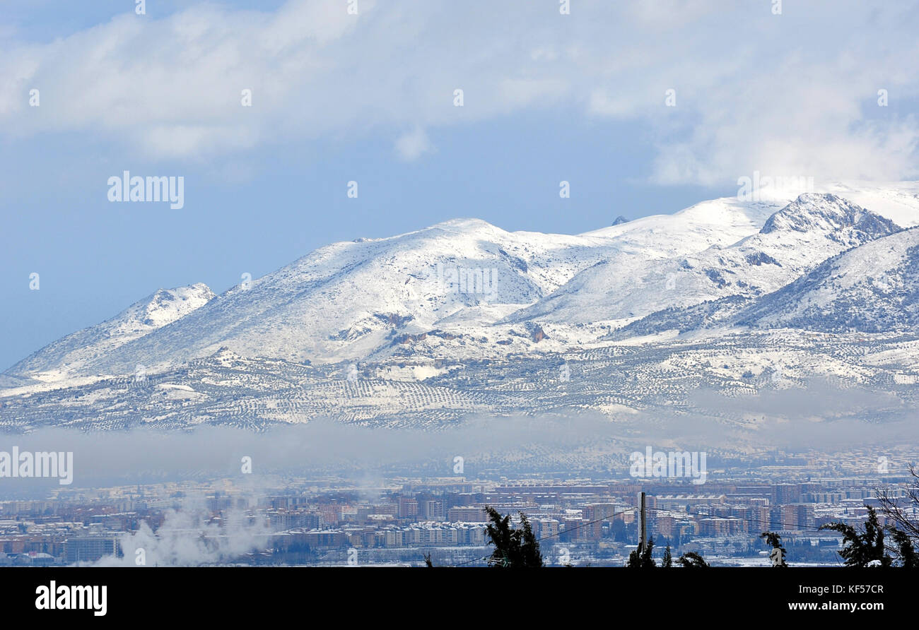 Snowy landscape with city, mountains floating and clouds Stock Photo ...