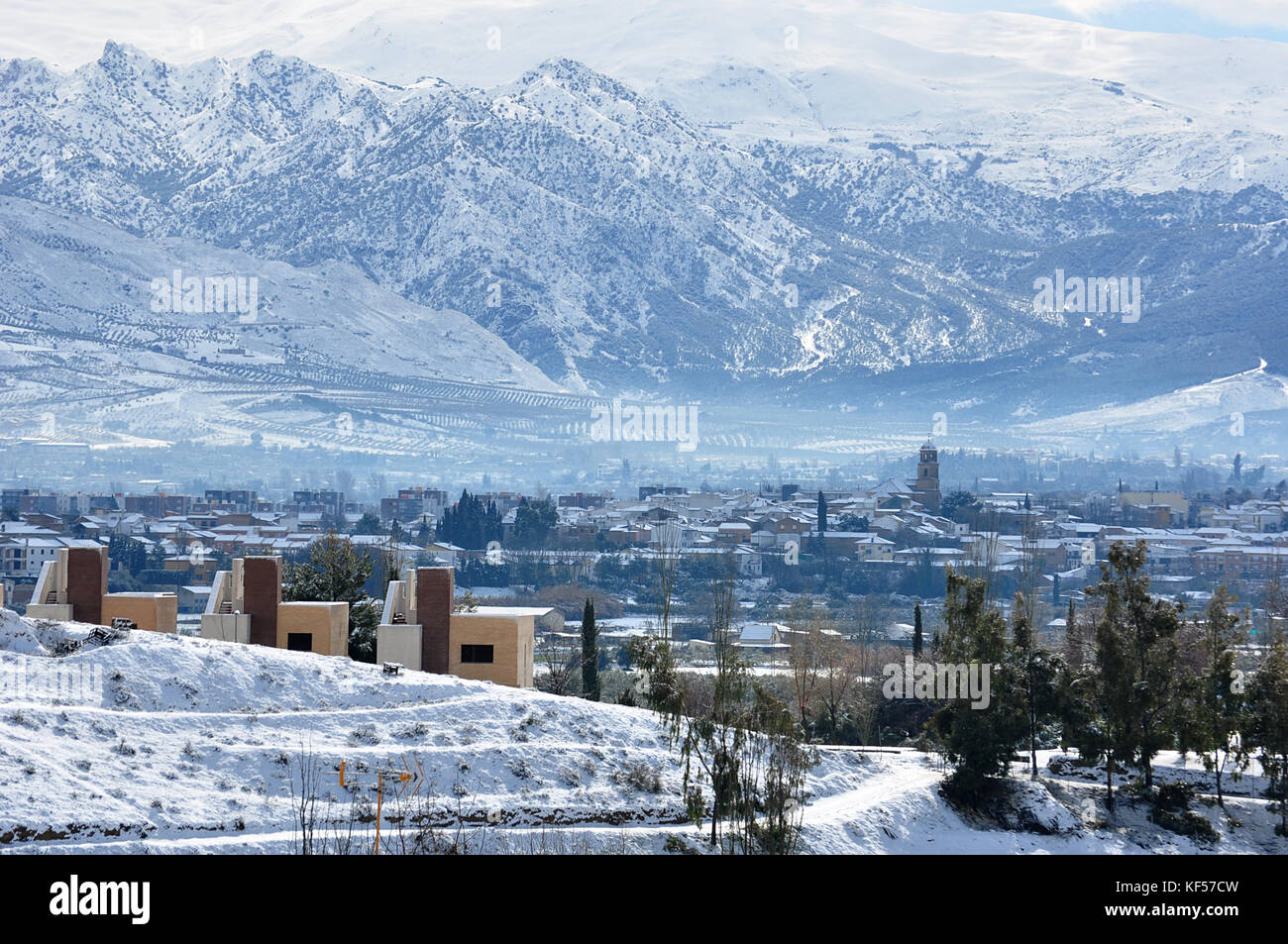 Snowy landscape with city, mountains and clouds Stock Photo - Alamy
