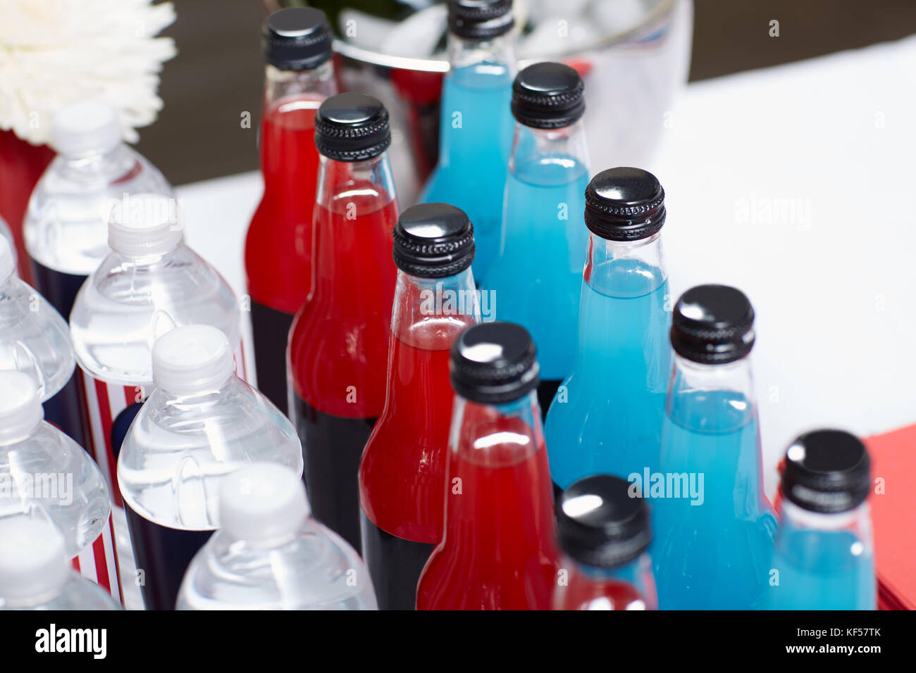 Close up view of bottles with water and colorful beverages standing on ...