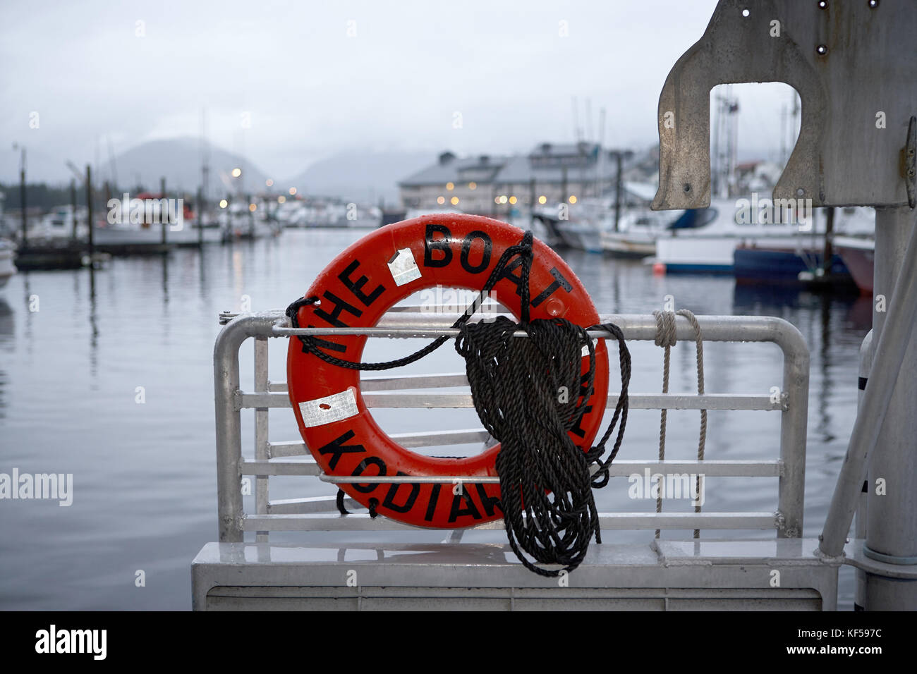 Red life preserver or life ring attached to the metal railing on a boat ...