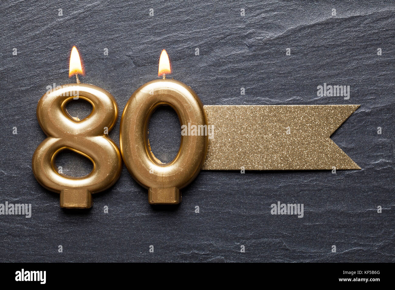 Gold number 80 celebration candle with glitter label Stock Photo - Alamy
