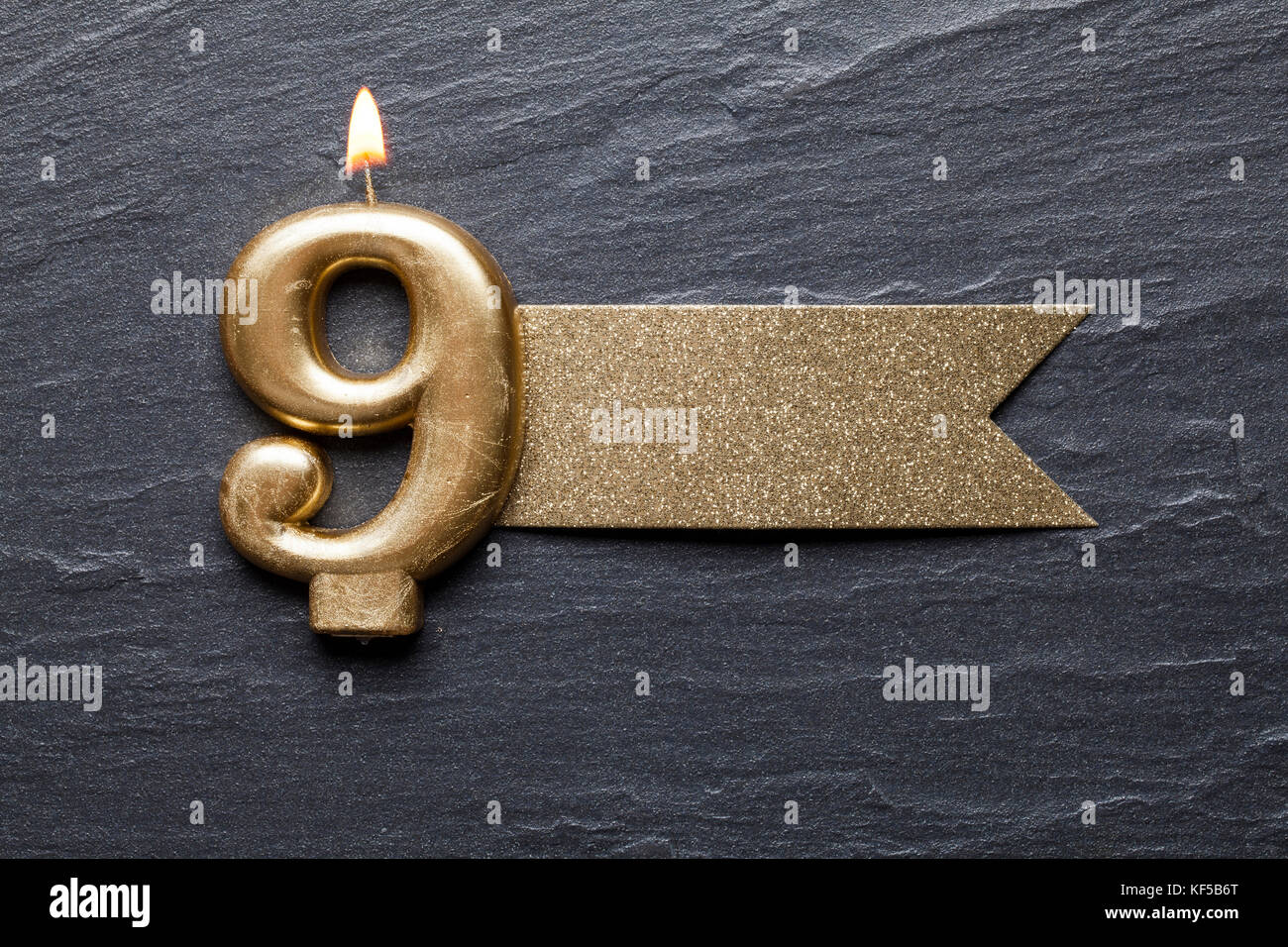 Gold number 9 celebration candle with glitter label Stock Photo - Alamy