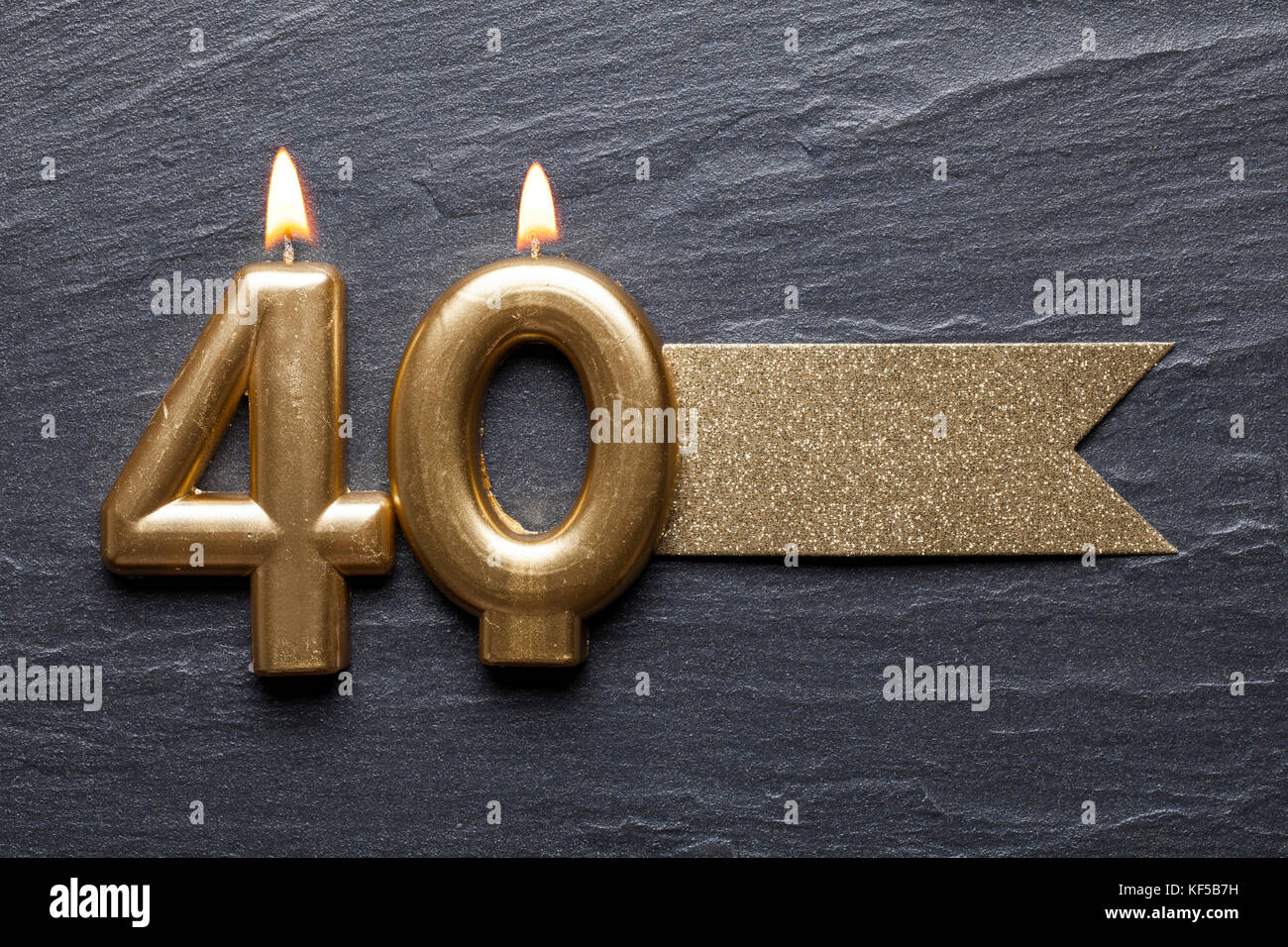 Gold number 40 celebration candle with glitter label Stock Photo - Alamy