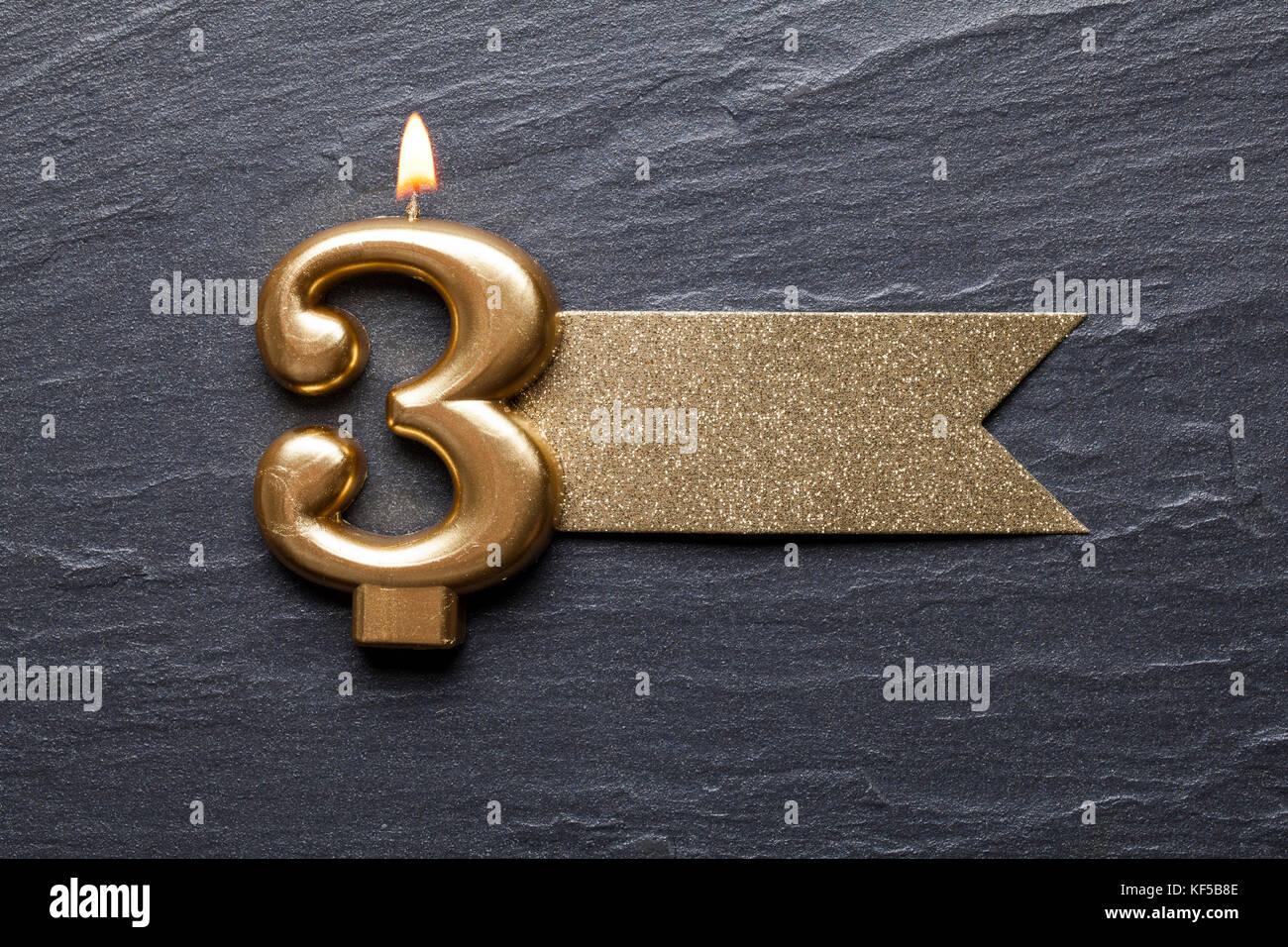Gold number 3 celebration candle with glitter label Stock Photo - Alamy