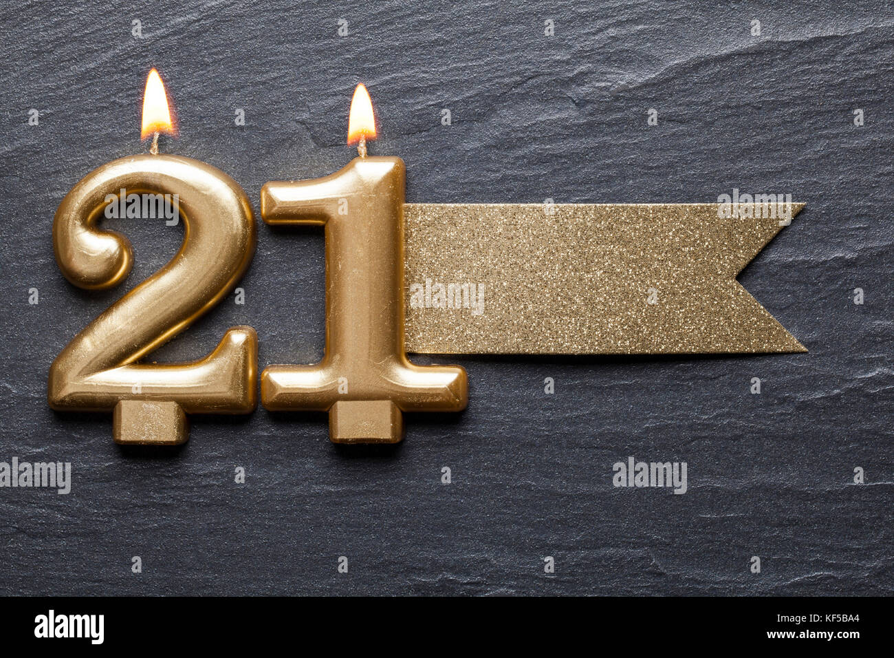 Gold number 21 celebration candle with glitter label Stock Photo - Alamy