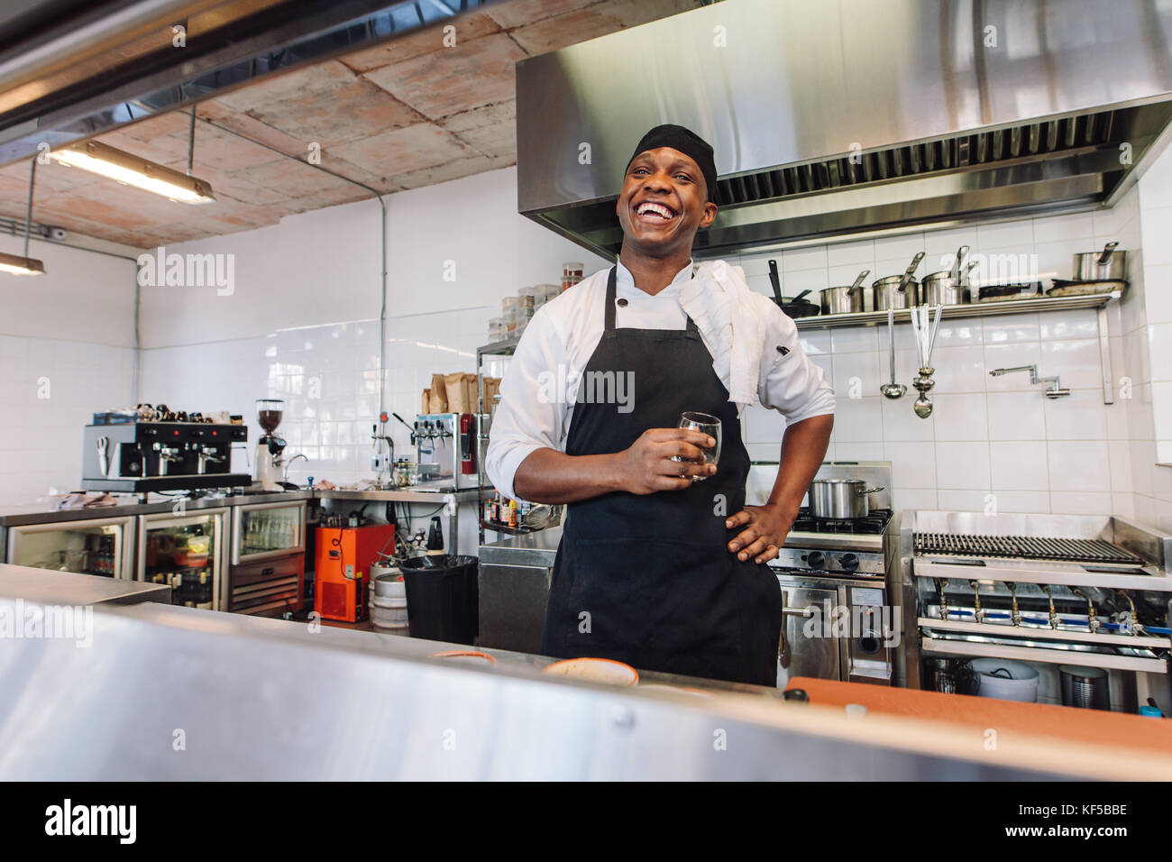 Gourmet chef taking a break from cooking at restaurant kitchen. Male ...