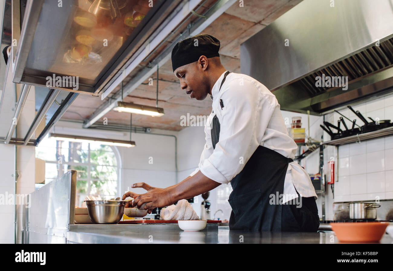 Restaurant chef preparing food. Chef working in a commercial kitchen ...