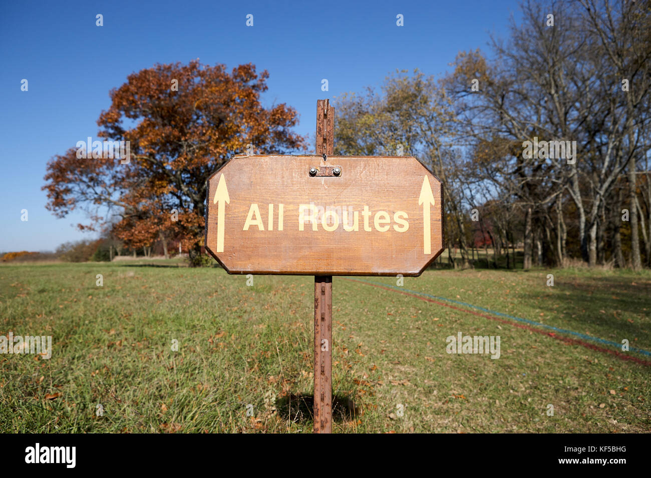 All Routes wooden sign with directional arrows pointing straight ahead ...