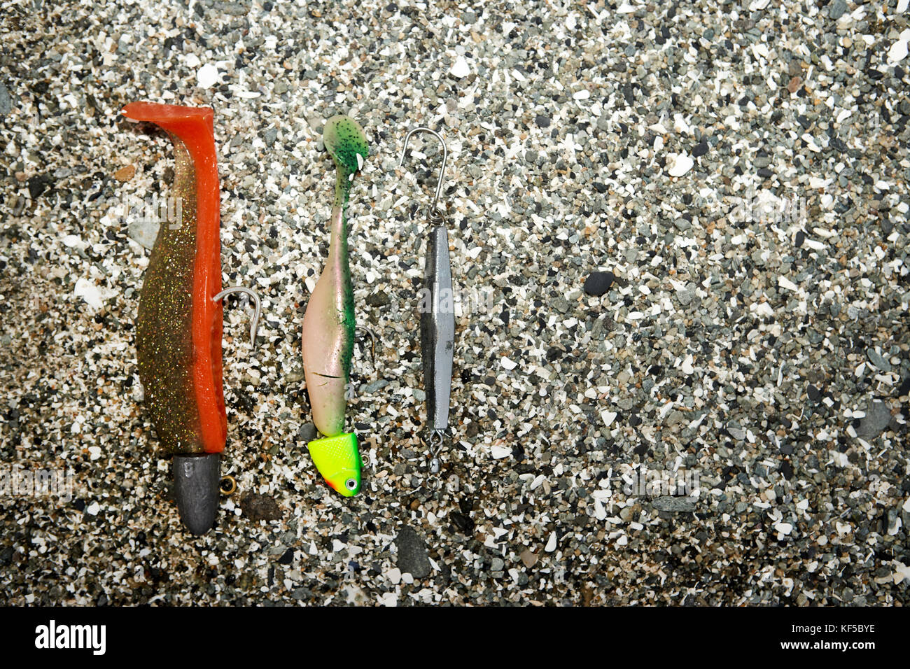 Different types of fishing baits lying against large-grained sand Stock ...