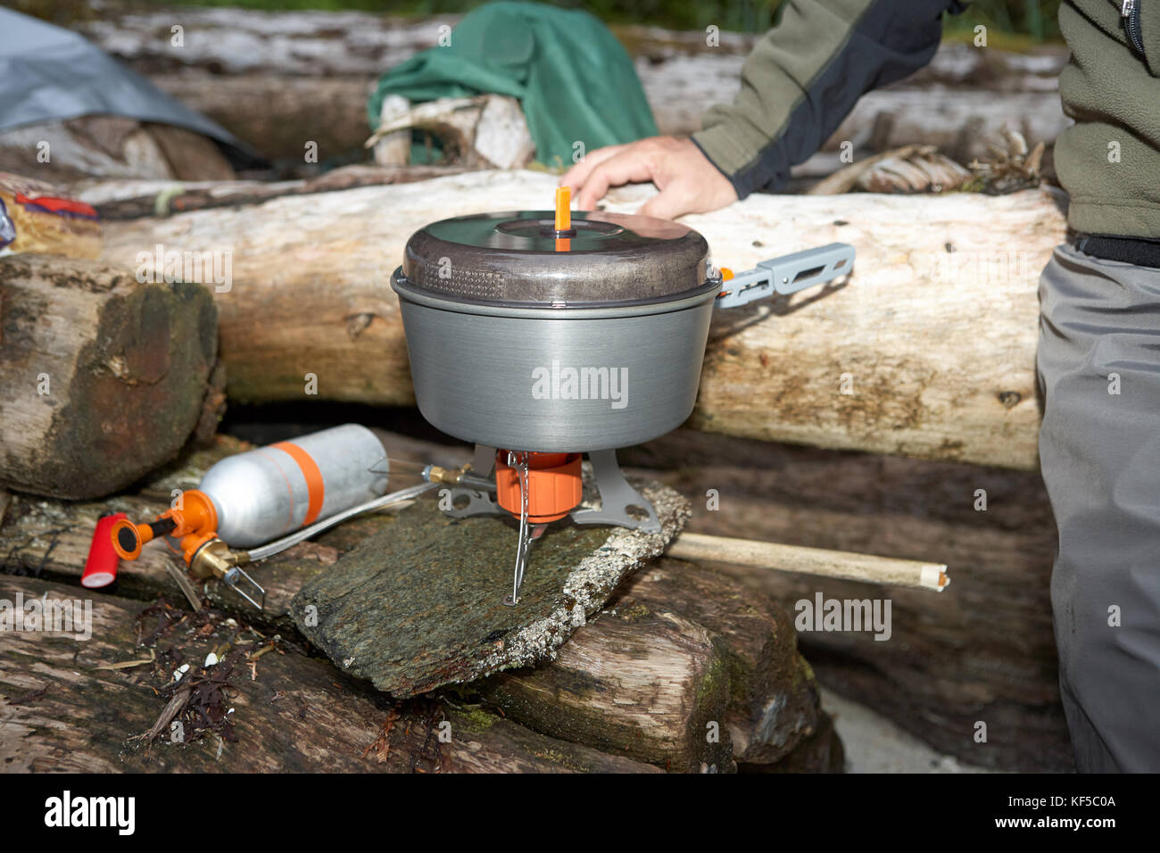 Man boiling water using camping gas stove Stock Photo - Alamy