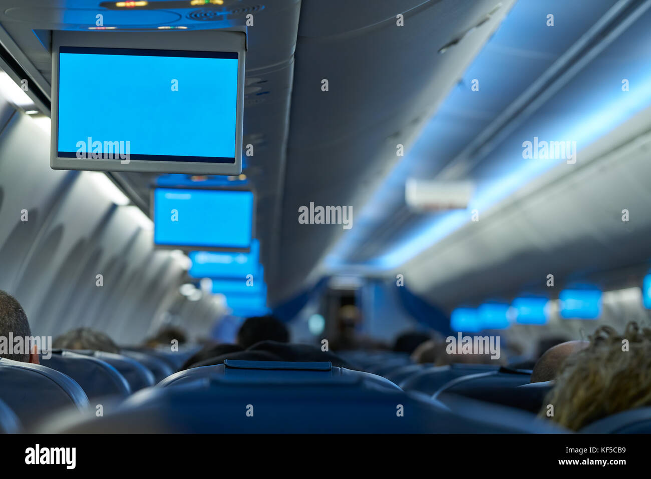 Aircraft indoor tv screens in a row selective focus Stock Photo - Alamy