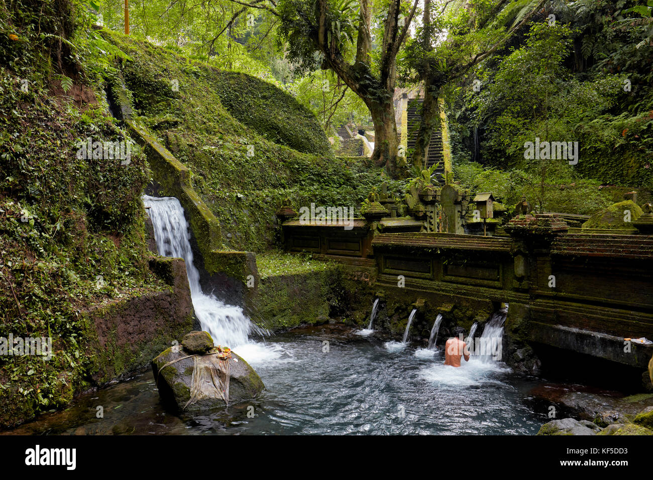 An Indonesian man bathing in the men's half of bathing pool at the ...