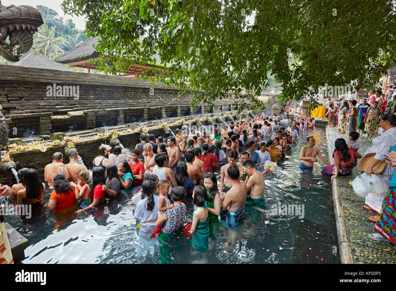People waiting in line to make ritual purification in the holy spring ...