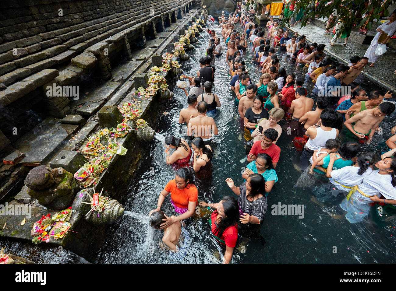 People waiting in line to make ritual purification in the holy spring ...