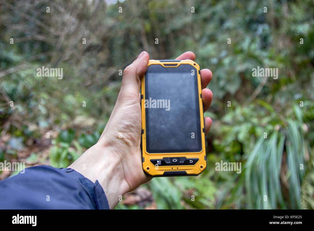 smartphone tracking travel on mountain trails. Phone in hand in a ...