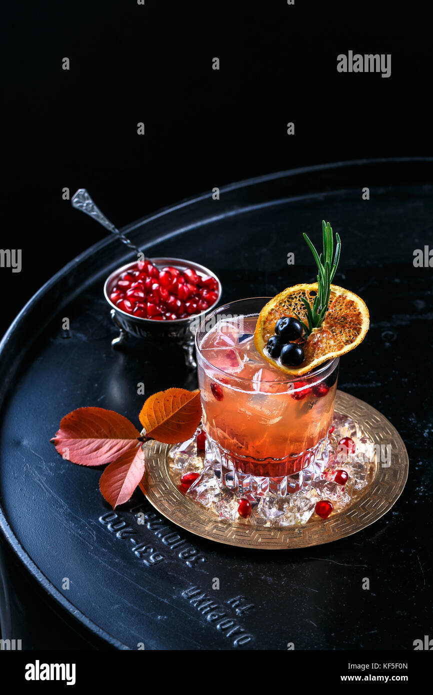 Red alcoholic cocktail with vodka and juice on a black background with ...