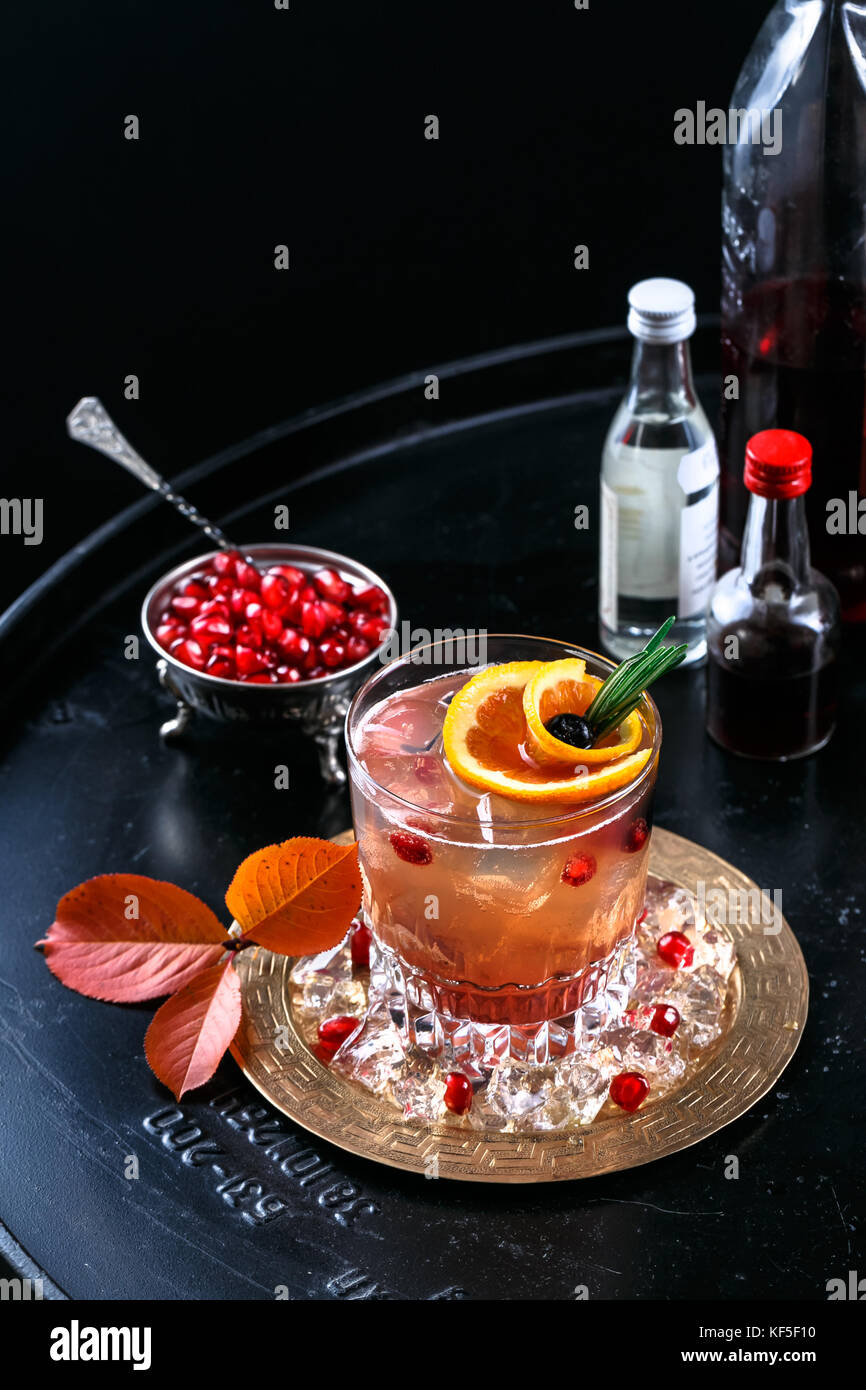 Red alcoholic cocktail with vodka and juice on a black background with ...