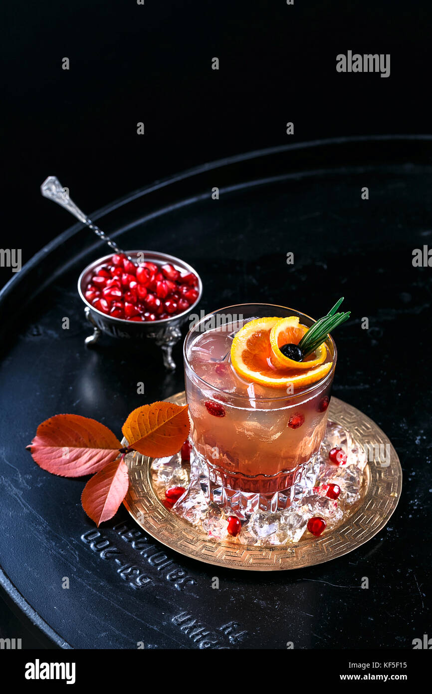 Red alcoholic cocktail with vodka and juice on a black background with ...