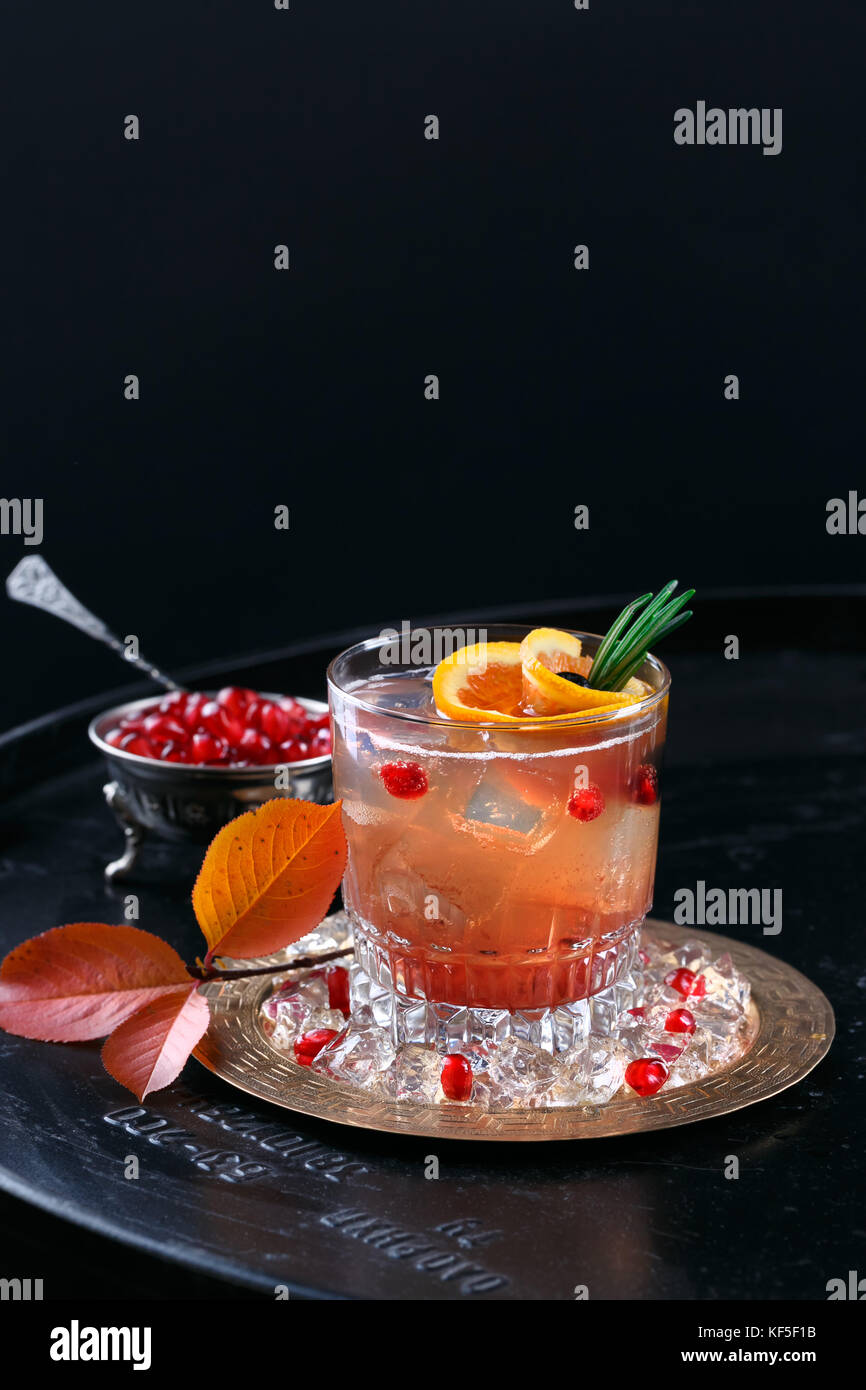 Red alcoholic cocktail with vodka and juice on a black background with ...