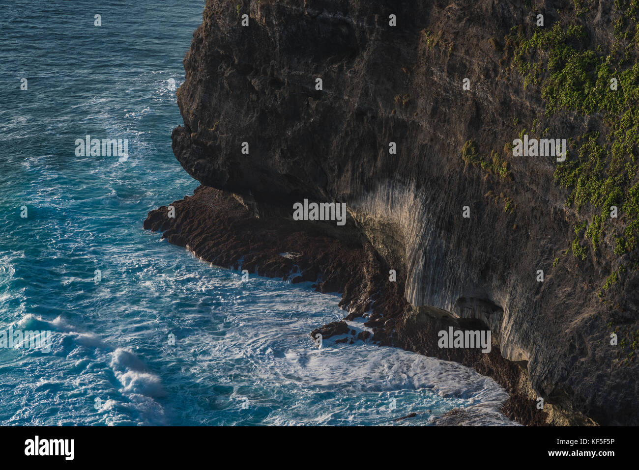 Waves hit the rock. Famous Uluwatu temple in Bali, Indonesia Stock ...