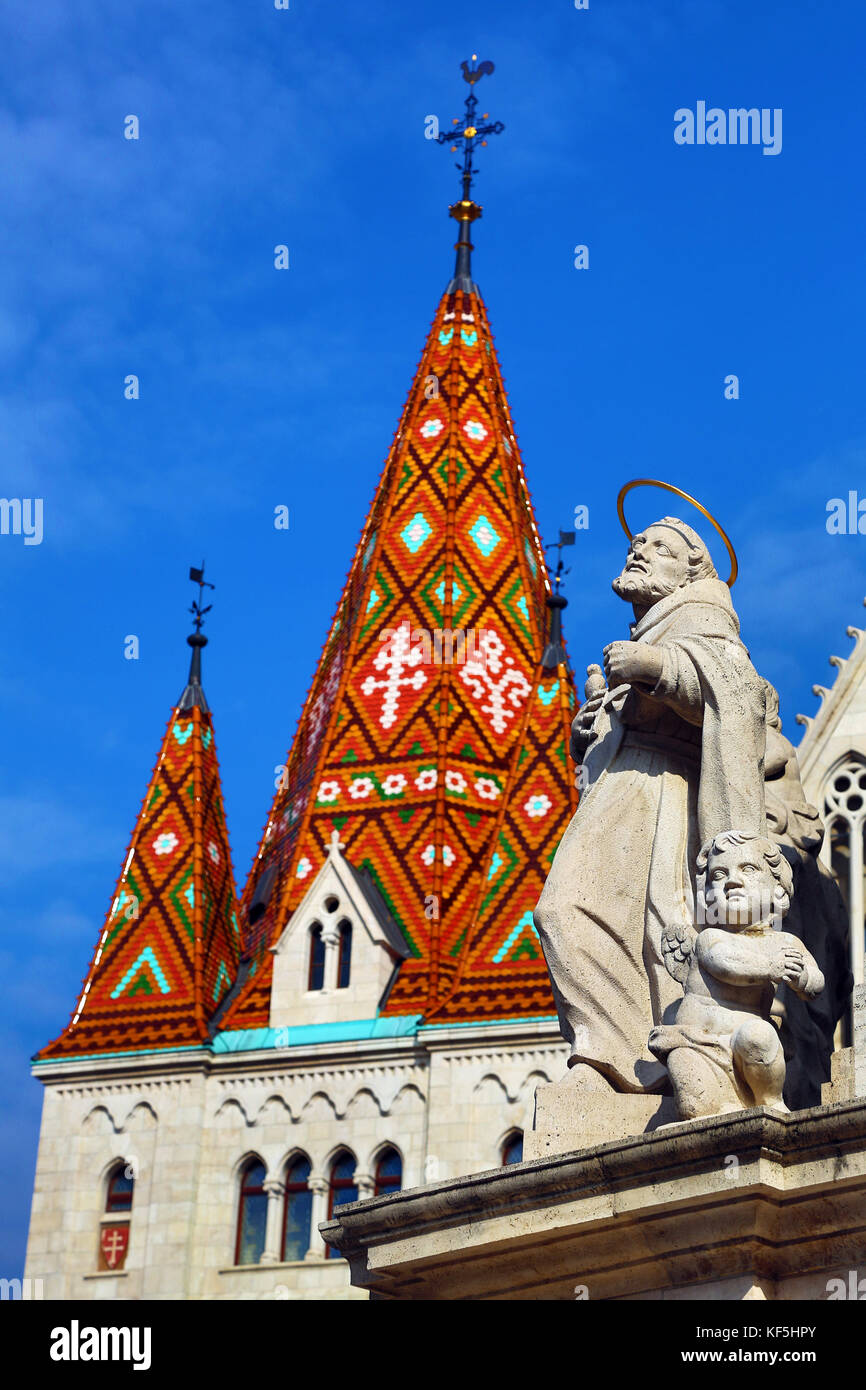 Statue on Holy Trinity Column and traditional tiled roof of the ...