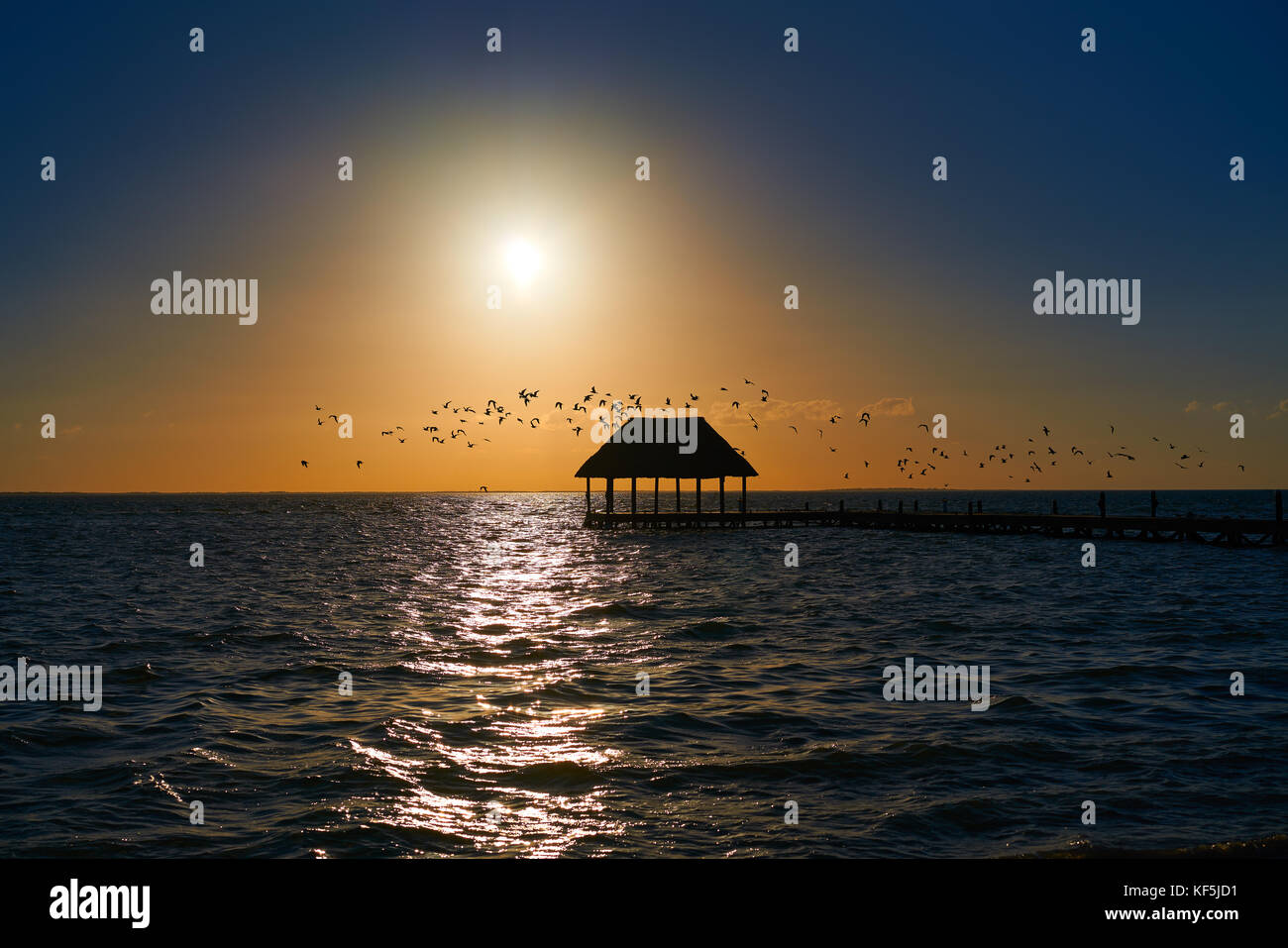 Holbox island sunset beach tropical hut pier in Mexico Stock Photo - Alamy