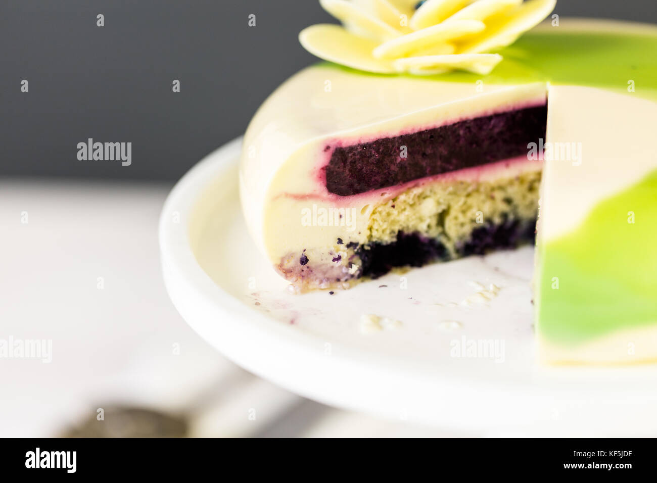 Sliced mousse cake with mirror glaze on the table Stock Photo - Alamy