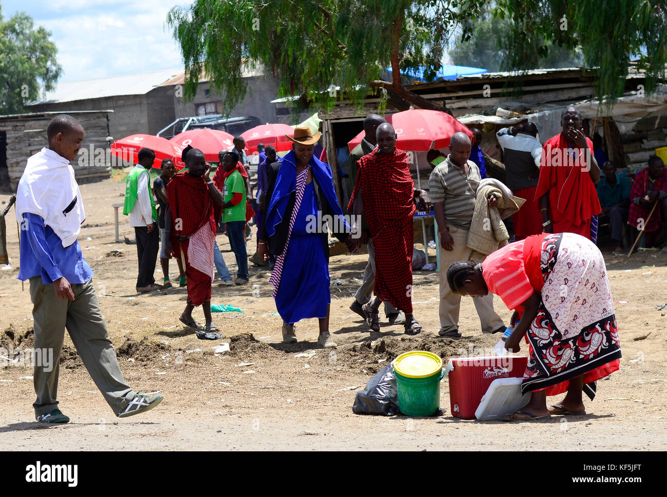 Maasai tribesmen in a colorful cattle and fresh produce market in ...