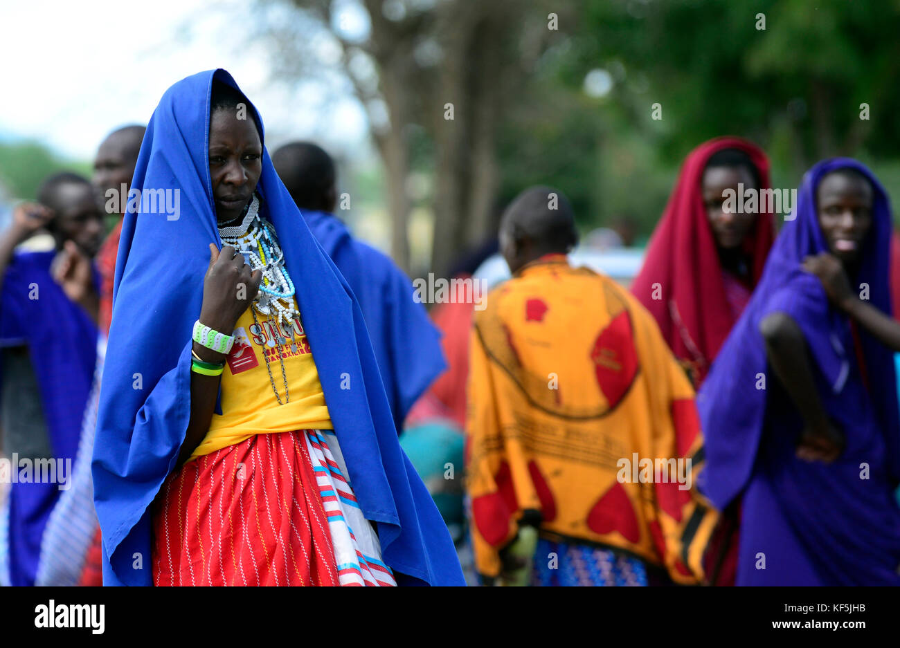 Maasai tribesmen in a colorful cattle and fresh produce market in ...