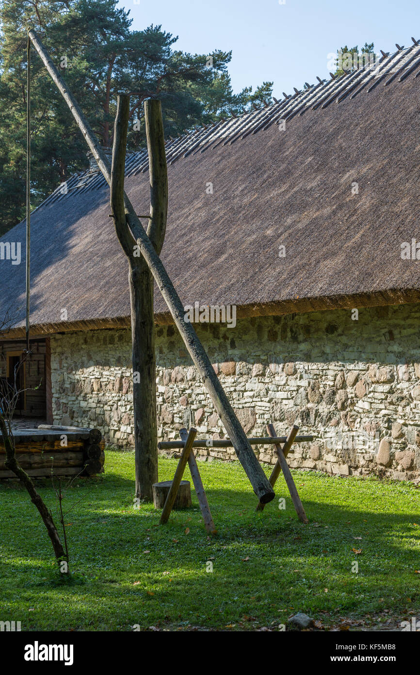 Traditional wooden country hut and well Stock Photo - Alamy