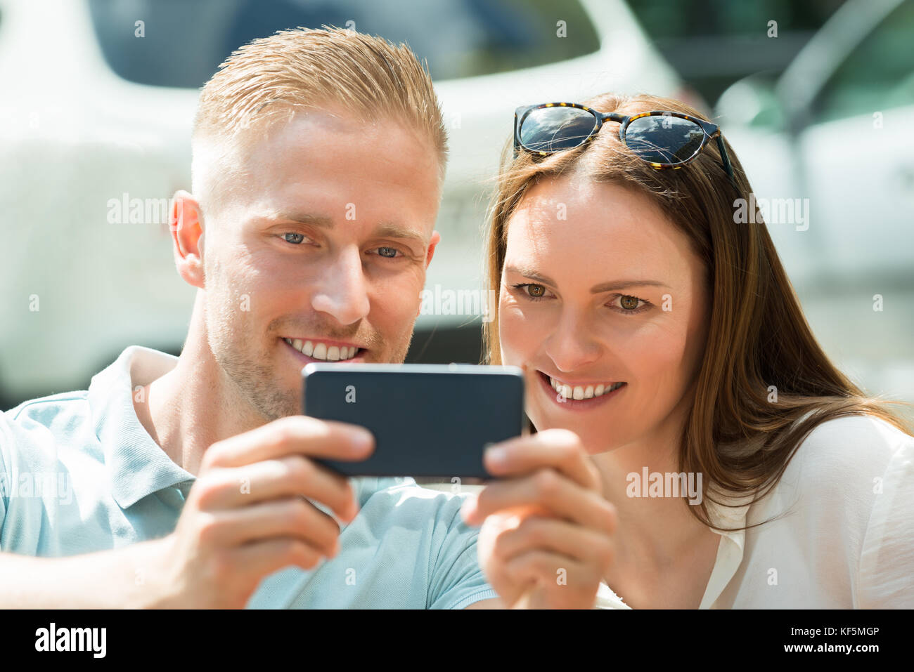 Happy female friends using smartphone hi-res stock photography and ...
