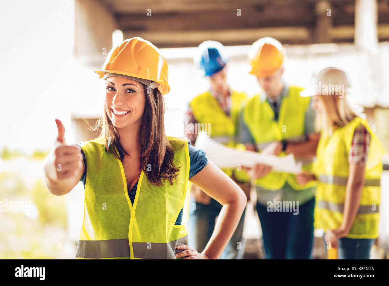 Beautiful young female construction architect at a construction site ...