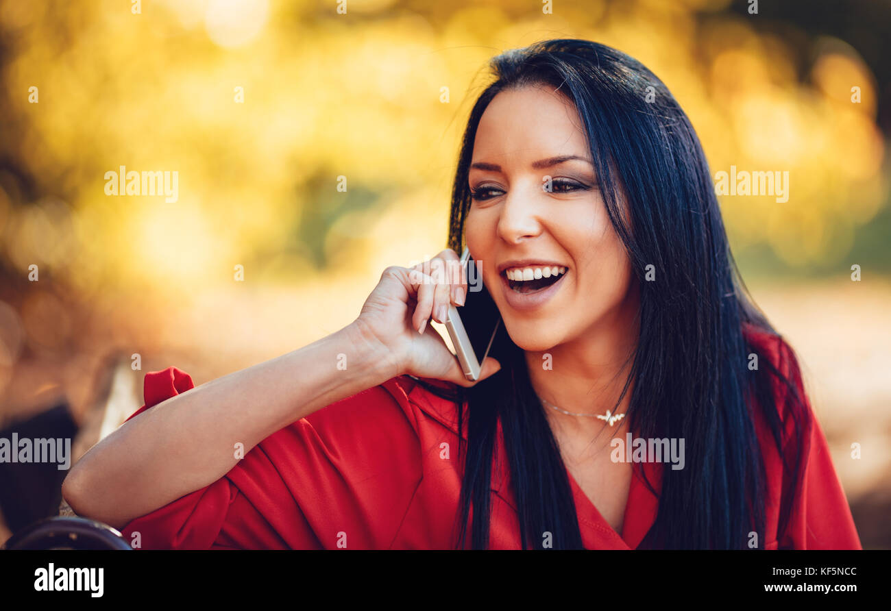 Portrait of a cheerful young woman who listen very good news on ...