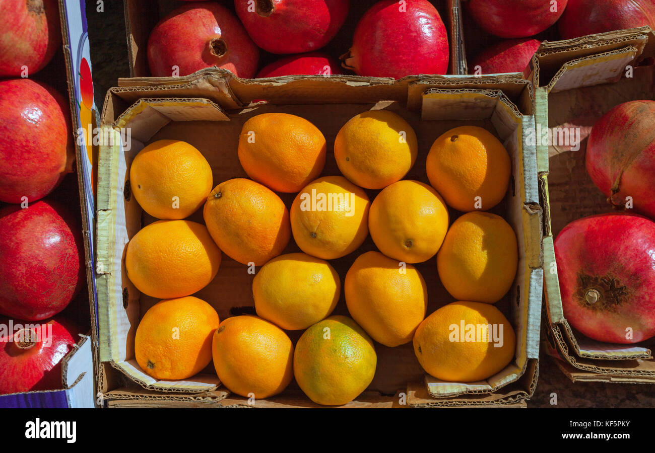 Pomegranates and lemons in paper boxes Stock Photo - Alamy