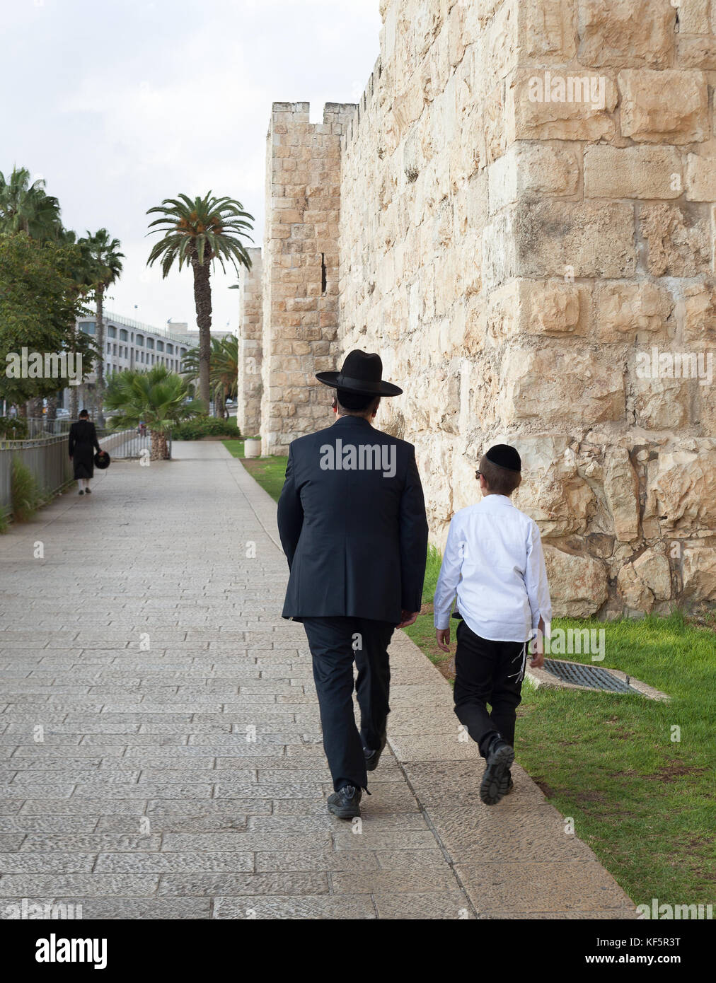 Jewish man and kid walking in Jerusalem Stock Photo - Alamy