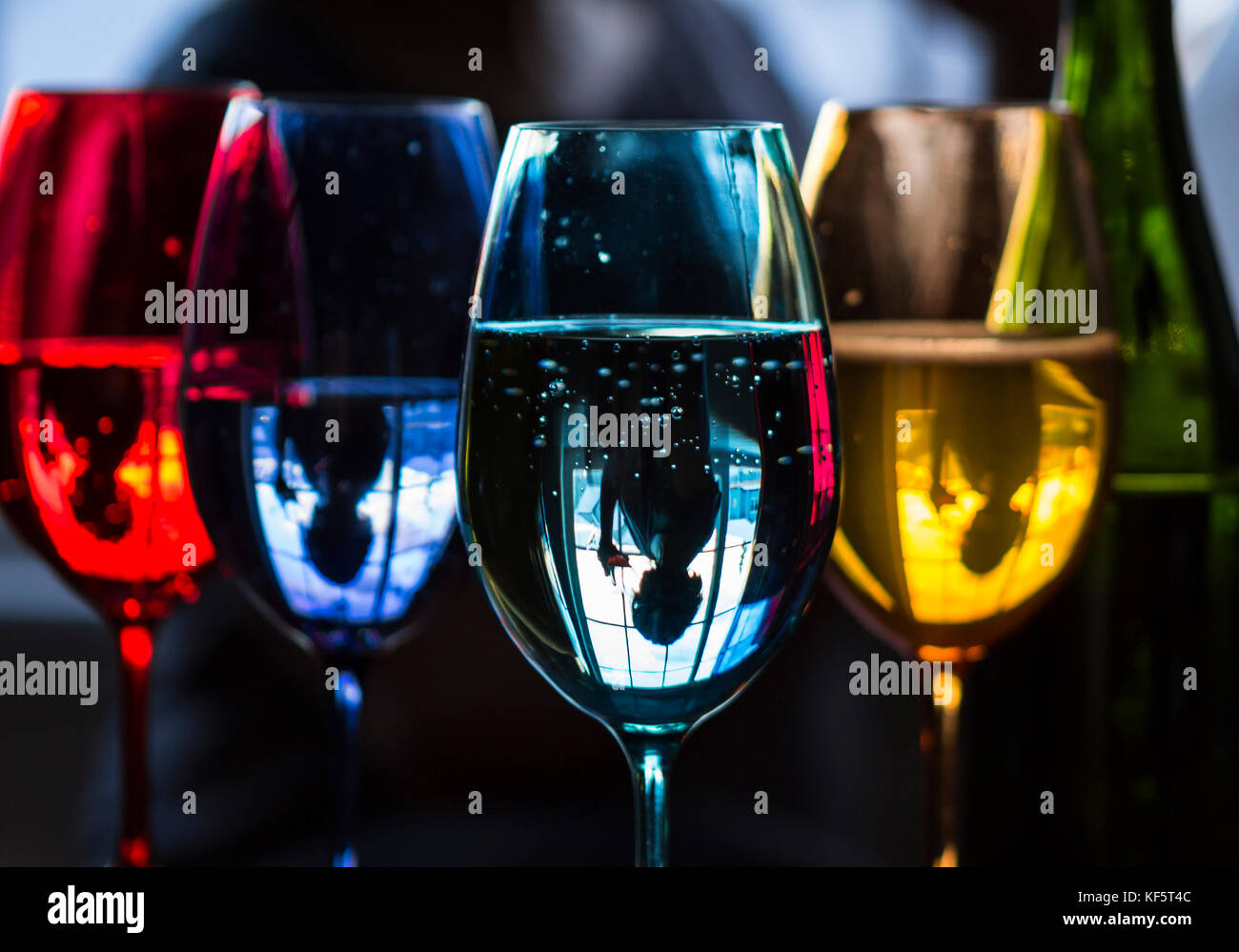 Portrait of woman having a drink by window. Upside-down reflection in ...